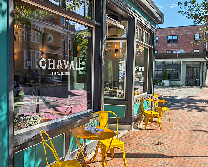 Cheerful yellow tables brighten the sidewalk dining area, creating an inviting spot to people-watch while savoring Spanish-inspired delights.