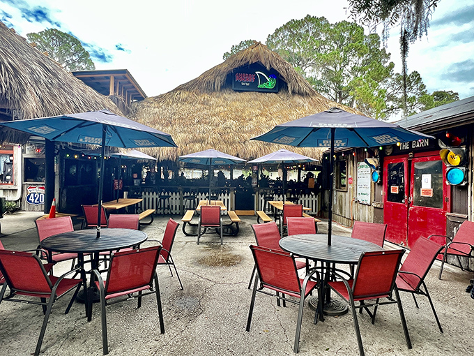 Outdoor seating under thatched umbrellas creates natural conversation nooks &ndash; where Lake Pierce views transform throughout the day.