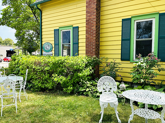 White wrought iron furniture on lush green lawns offers al fresco dining with a side of Minnesota's gorgeous summer weather.