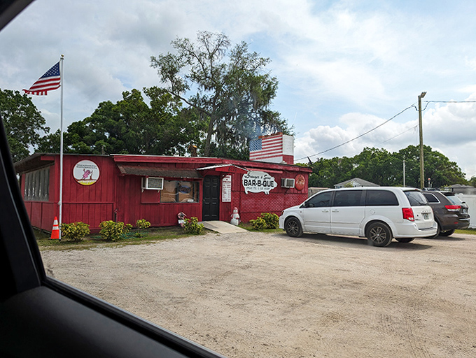 The parking lot view that makes hungry travelers slam on brakes. That American flag isn't just decoration&mdash;it's a beacon for barbecue pilgrims.