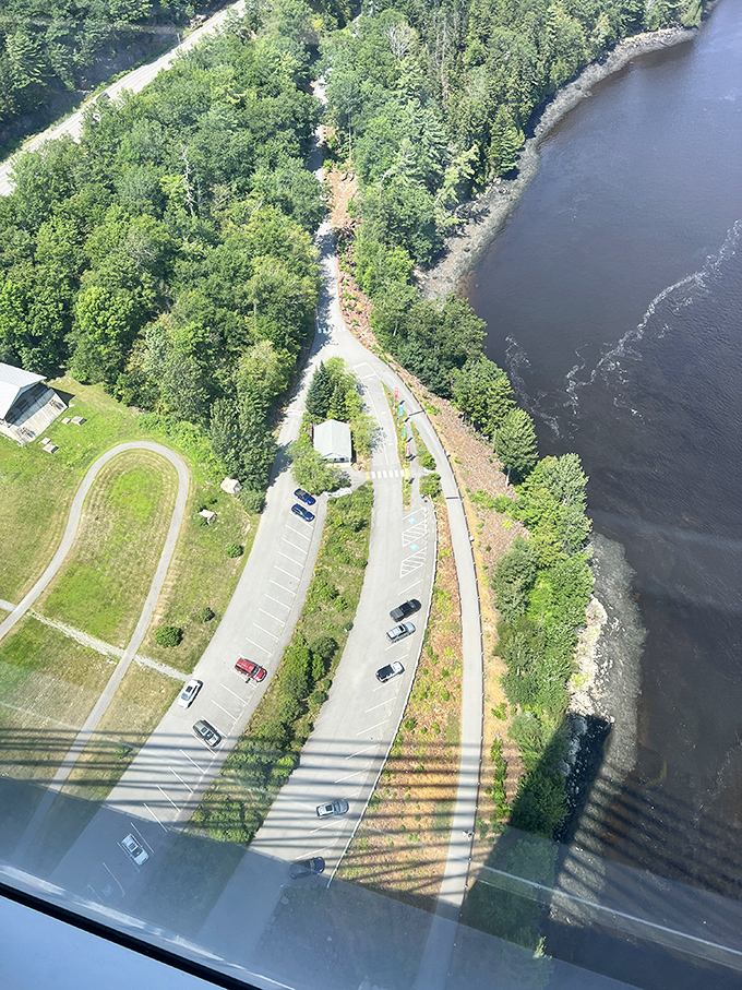 Looking down from 420 feet, the parking area and shoreline create an unexpected abstract pattern &ndash; everyday scenes transformed into art from this height.