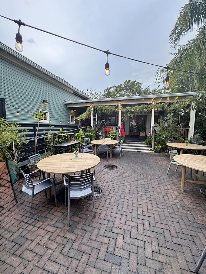 The charming brick patio, strung with twinkling lights, offers al fresco dining that captures the essence of laid-back Florida evenings.