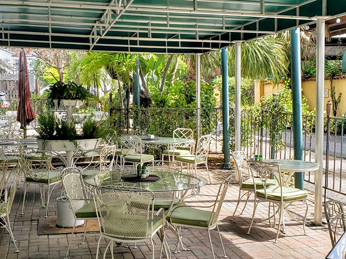 Dappled sunlight filters through lush greenery in this outdoor oasis where breakfast tastes even better with a side of fresh air.