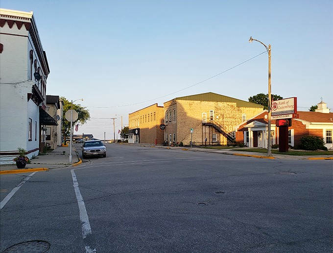Golden hour bathes Algoma's historic downtown in warm light, where century-old buildings stand as testaments to the town's enduring character.