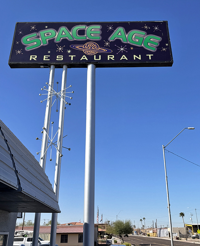 The distinctive Space Age Restaurant sign against the clear Arizona sky promises visitors an experience that's truly out of this world.