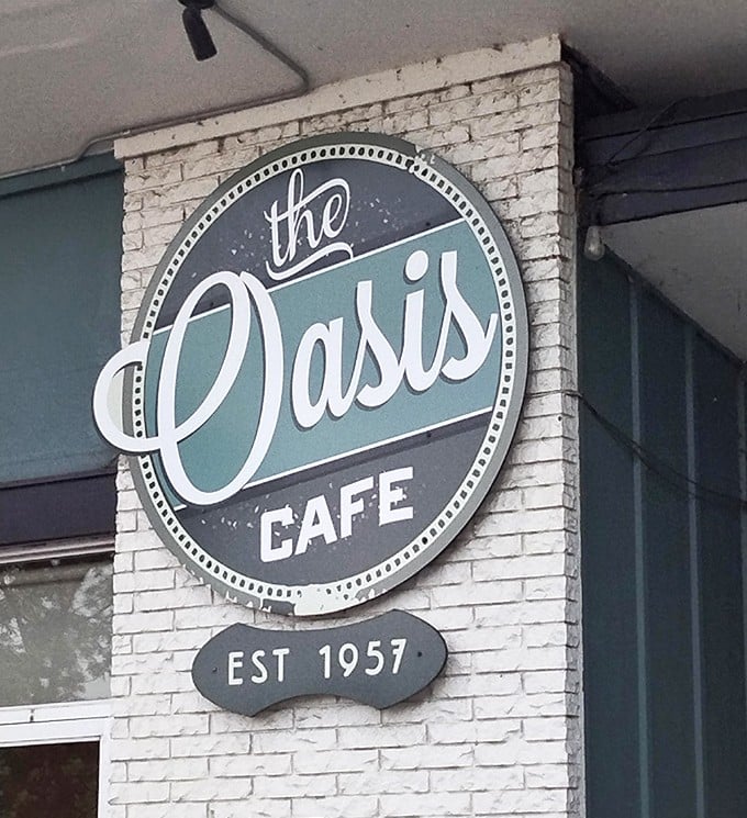 The iconic Oasis Cafe sign – a beacon of hope for the burger-obsessed and hungry travelers alike.