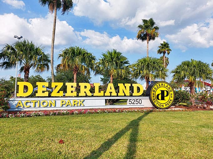 The Dezerland Park sign stands tall among Florida palms – promising air-conditioned adventures when the sunshine state lives up to its name.