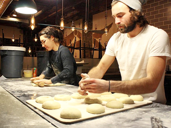 Skilled hands shape tomorrow's bagels, a reminder that behind every perfect breakfast is dedication to craft and quality ingredients.