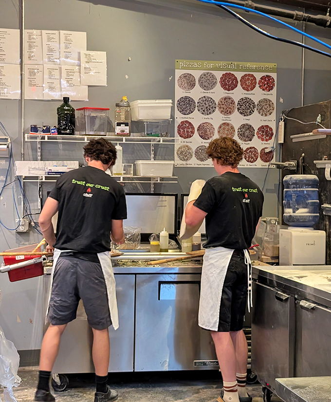 Pizza artisans at work, crafting each pie with care and precision that translates directly to your taste buds.