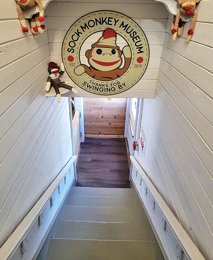 The stairway entrance invites visitors to descend into a world where thousands of sock monkeys await their arrival.