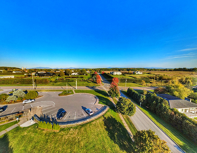 From above, the park reveals its perfect positioning, a green oasis strategically placed to capture Vermont's most breathtaking panorama.