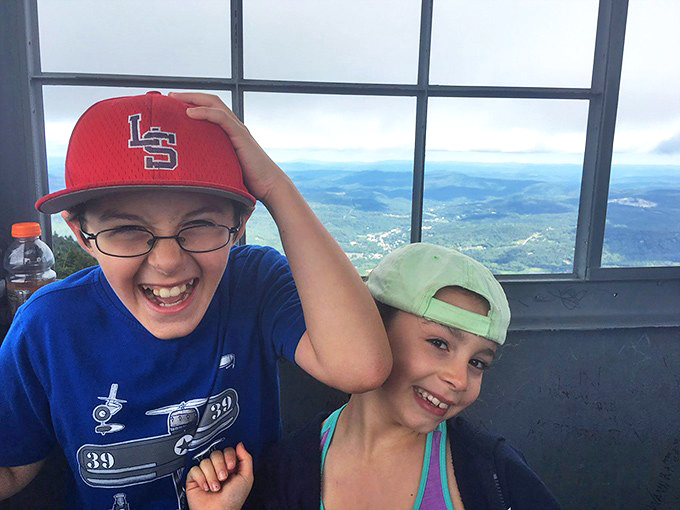 Young explorers discover the thrill of height and horizon at the tower's summit, where childhood wonder meets adult-approved adventure.