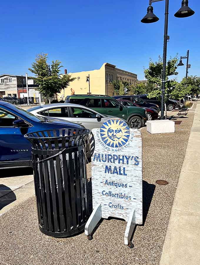 Murphy's sidewalk sign stands like a cheerful sentinel, its sun-face logo beckoning passersby into a world where yesterday's treasures become tomorrow's heirlooms.