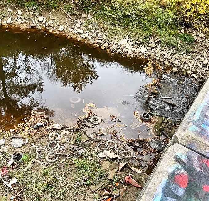Silver Creek flows silently beneath the infamous bridge, carrying away secrets while reflecting fragments of colorful history.