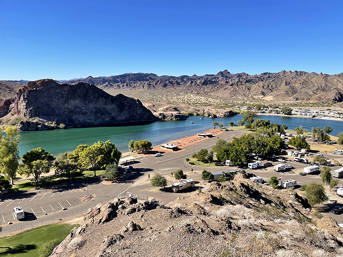 The Colorado carves its ancient path between mountains and civilization, revealing the perfect harmony of water, desert, and human presence.