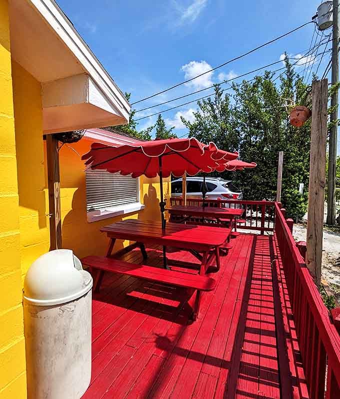 The red deck with matching picnic tables &ndash; where time slows down just enough to remember what food is supposed to taste like.