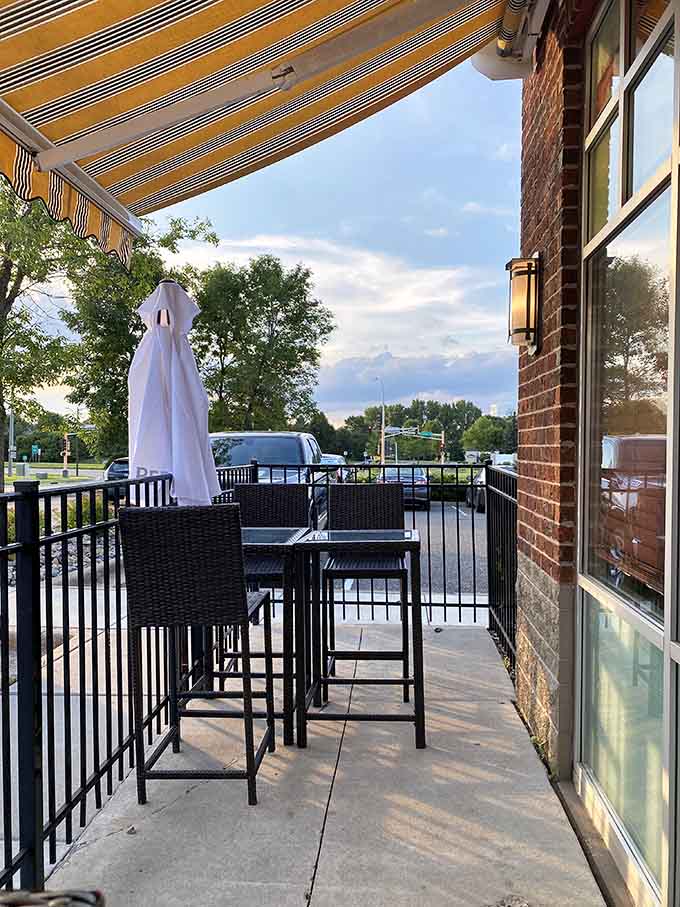Outdoor seating with striped awnings offers al fresco dining when Minnesota weather decides to cooperate for once.