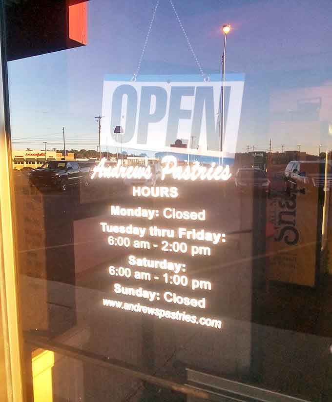 The window sign announces the bakery's hours &ndash; a crucial piece of information for planning your sugar fix and avoiding the heartbreak of arriving to closed doors.