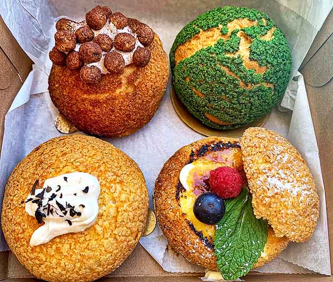 A quartet of cream puffs showcasing the rainbow of possibilities &ndash; because life's too short to limit yourself to just one flavor.