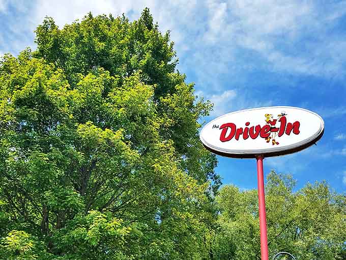 The Drive-In sign stands tall against Michigan's blue sky, promising delicious memories just around the corner.