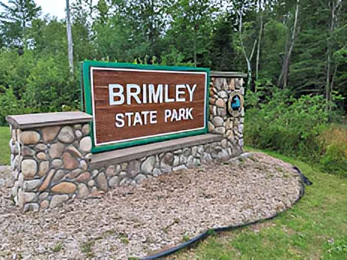 The park's entrance sign stands as a gateway between everyday life and the natural sanctuary that awaits beyond.
