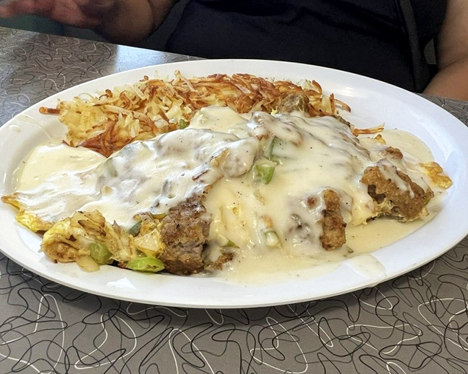 The chicken fried steak omelet represents breakfast ambition at its finest – a glorious collision of two comfort food favorites on one plate.