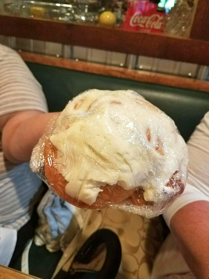 The grand finale! This glistening spiral of cinnamon-sugar bliss, crowned with cream cheese frosting, is worth saving room for.