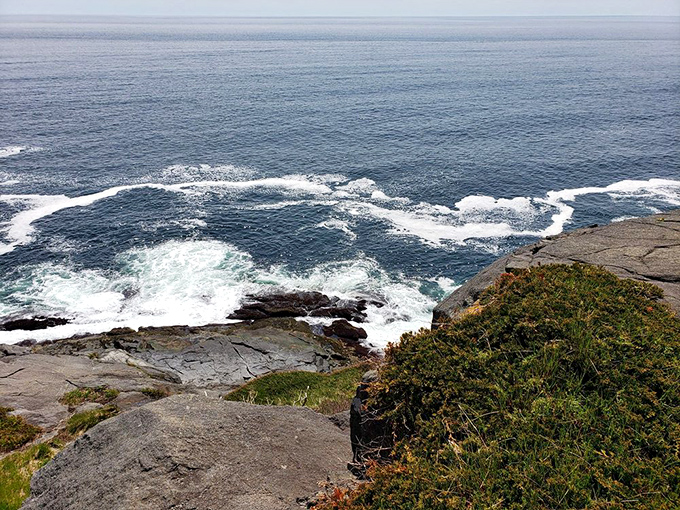 Waves crash against Monhegan's rugged shoreline, a timeless dance between granite and sea that shapes the island's character.