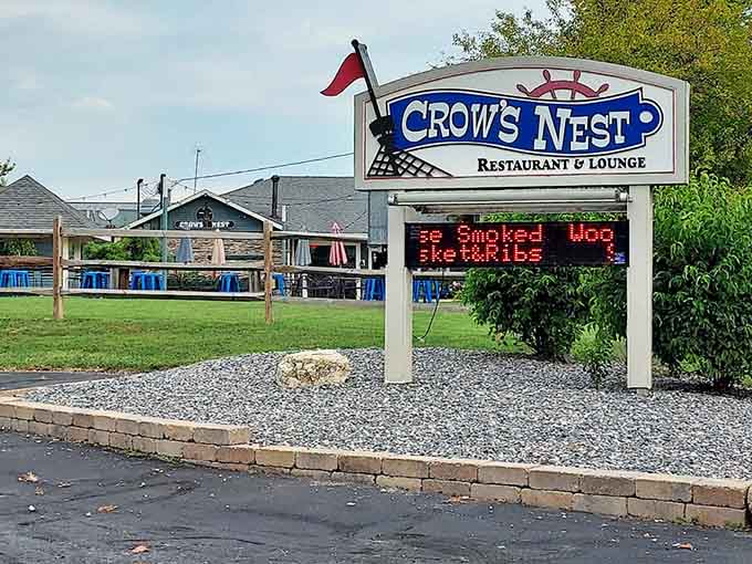 The Crow's Nest sign welcomes visitors with promises of smoked meats and good times by the beautiful lake.