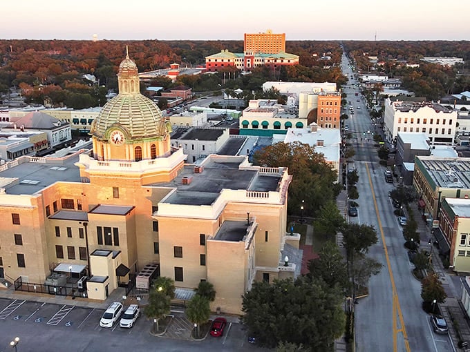 DeLand's magnificent courthouse dome gleams in the setting sun, anchoring a downtown that perfectly balances history with modern energy.