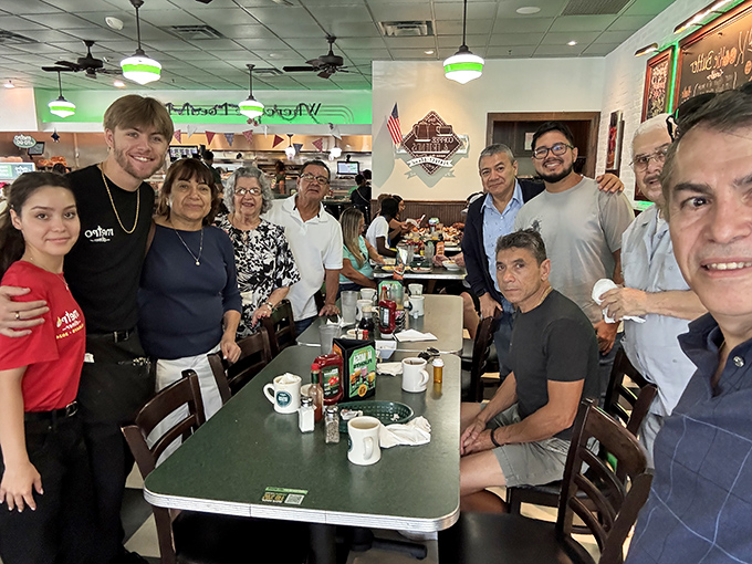 Happy diners gathered around a table &ndash; proof that good food brings people together better than any social media platform ever could.