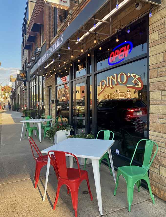 Outdoor seating with colorful chairs invites you to enjoy your pizza al fresco, weather permitting, because everything tastes better outside.