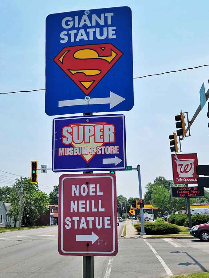 These directional signs point visitors toward giant statues and super-sized attractions, because in Metropolis, even the street signs understand the importance of proper superhero navigation and dramatic flair.