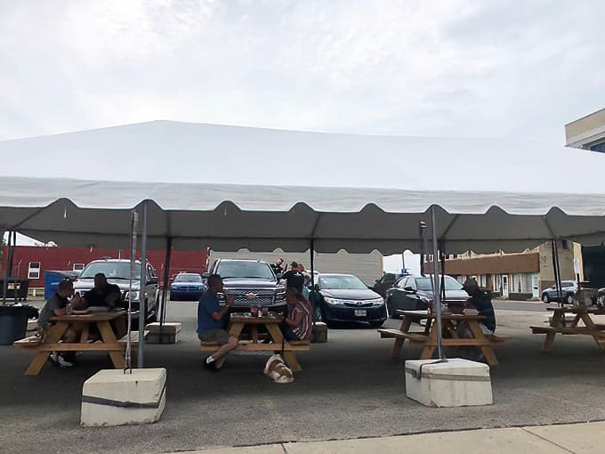 Picnic tables under cover provide additional seating options, making Don's a gathering spot for the entire Bellefontaine community.