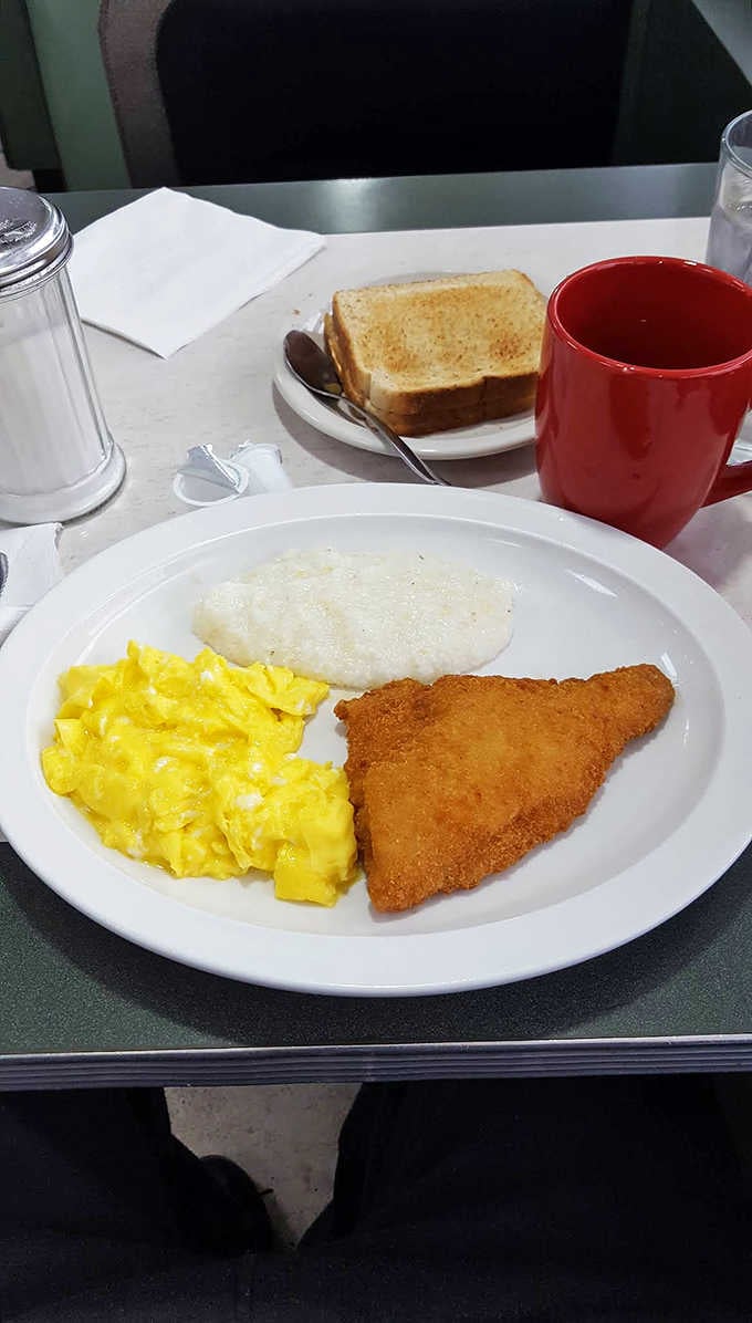 Southern comfort meets Cleveland charm in this golden trio of perfectly fried fish, creamy grits, and sunshine-yellow scrambled eggs.