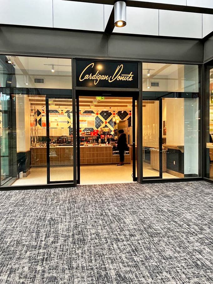The sleek exterior with its elegant Cardigan Donuts signage promises a modern twist on nostalgic flavors waiting just beyond those doors.
