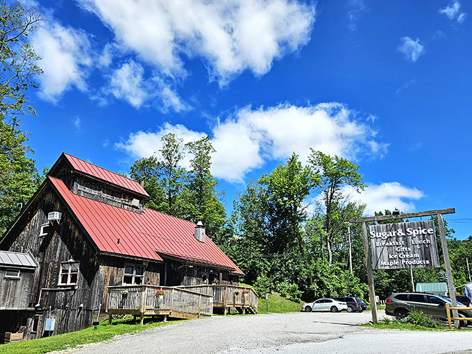 The sugar shack stands proudly against Vermont's blue sky, a beacon of breakfast hope for hungry travelers and locals alike.
