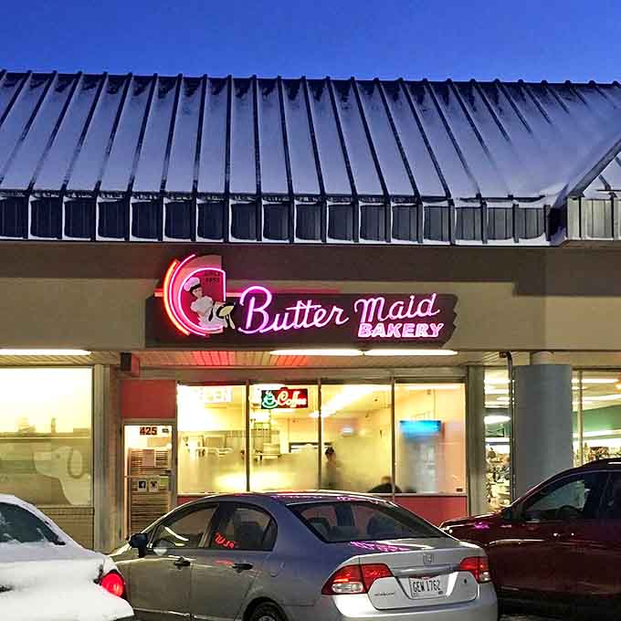 As evening falls, the neon Butter Maid sign transforms into a glowing promise of sweetness, beckoning night owls with dreams of tomorrow's treats.