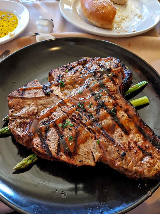 A carnivore's dream canvas, painted with perfect grill marks and drizzled with a sauce that makes taste buds stand at attention.