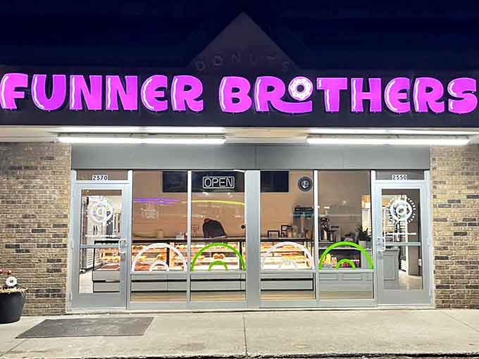 As night falls, the illuminated storefront glows like a beacon of sweetness &ndash; promising tomorrow's treasures for those who arrive before the inevitable sellout.