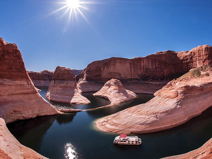 Glen Canyon's picturesque waters provide stunning contrast to the surrounding red rock landscape, a man-made oasis in the desert expanse.