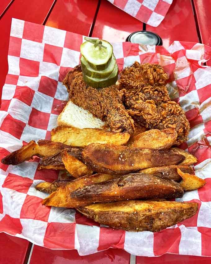 Golden-fried chicken perfection arrives with crispy fries and pickles&mdash;a basket of happiness that proves sometimes the simplest pleasures are the best.