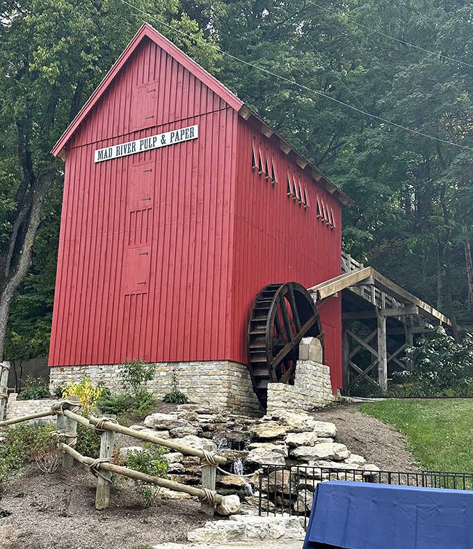 The vibrant red Mad River Pulp & Paper mill with its working water wheel demonstrates how natural power once transformed raw materials into the products of progress.