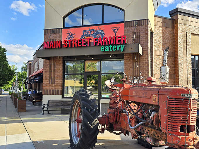 A vintage red Farmall tractor stands sentinel outside, reminding diners of the authentic farm-to-table philosophy that drives this beloved eatery.