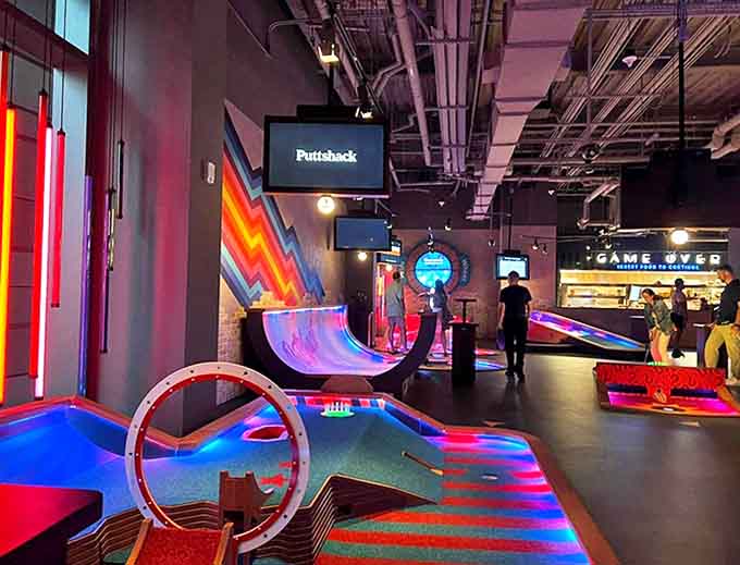 The venue transforms after dark, with neon pathways guiding players through an almost dreamlike landscape of interactive gaming experiences.