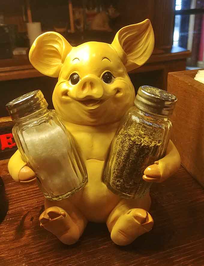 This cheerful pig holding salt and pepper perfectly captures the restaurant's fun-loving spirit and commitment to flavor in every bite.