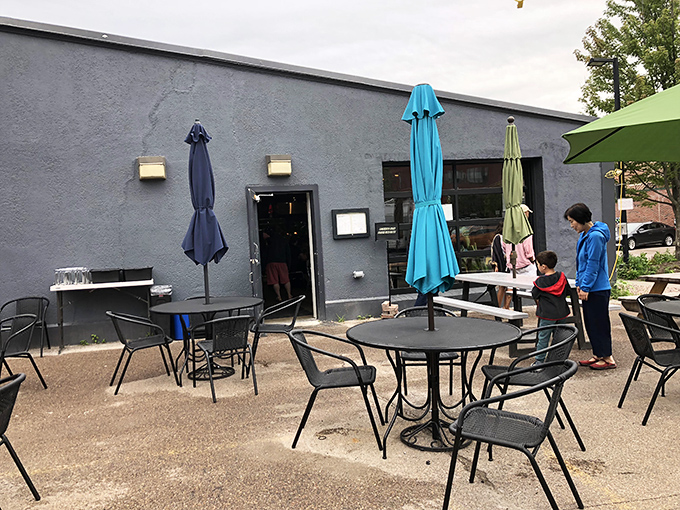 Green picnic tables under open skies &ndash; Folino's outdoor seating area invites you to linger over one more slice.