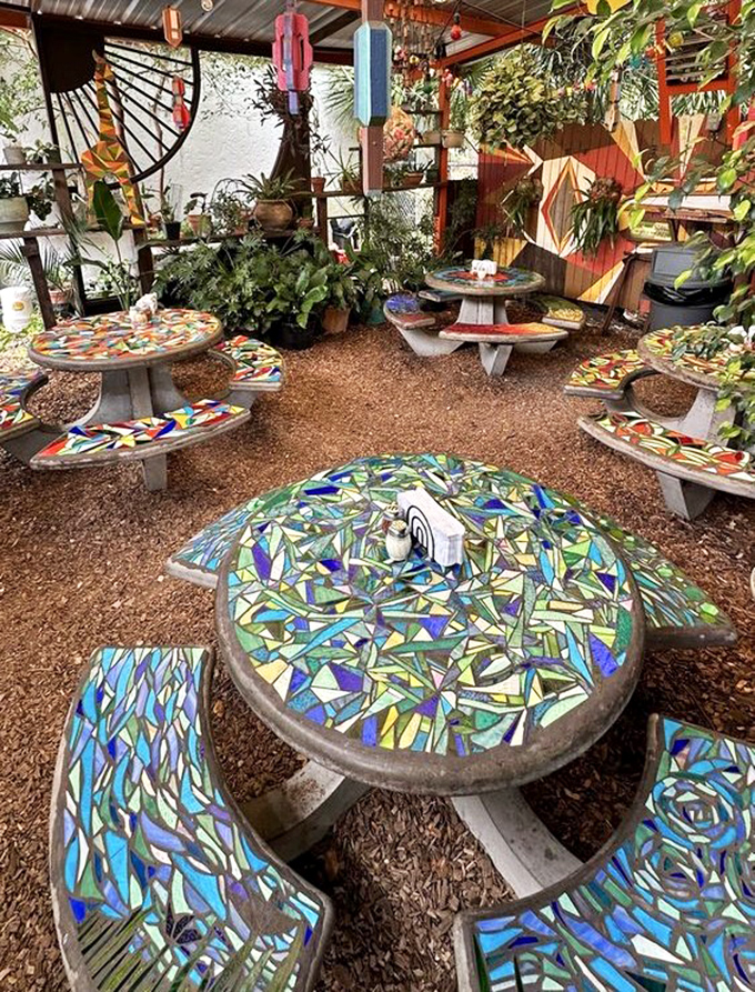 Mosaic-topped tables shimmer in the sunlight, each one a unique masterpiece that makes outdoor dining feel like an art gallery visit.