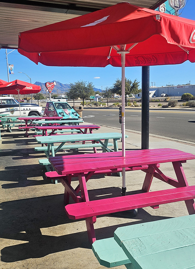 Colorful picnic tables under red umbrellas offer the perfect perch for people-watching on historic Route 66.