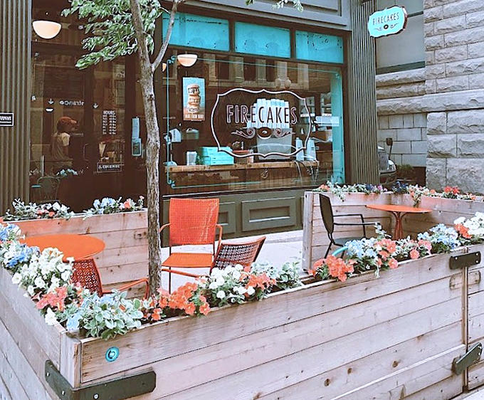 Outdoor seating surrounded by flowers creates a little oasis where you can contemplate life's important questions, like whether ordering another donut counts as dinner.